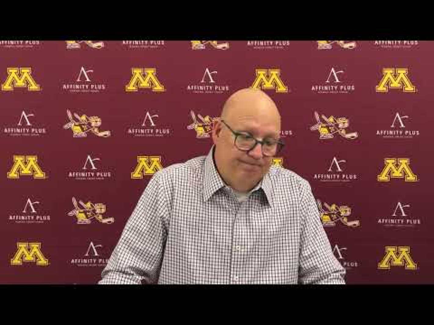 Gophers coach Bob Motzko, Jimmy Clark and Bryce Brodzinski following a ...